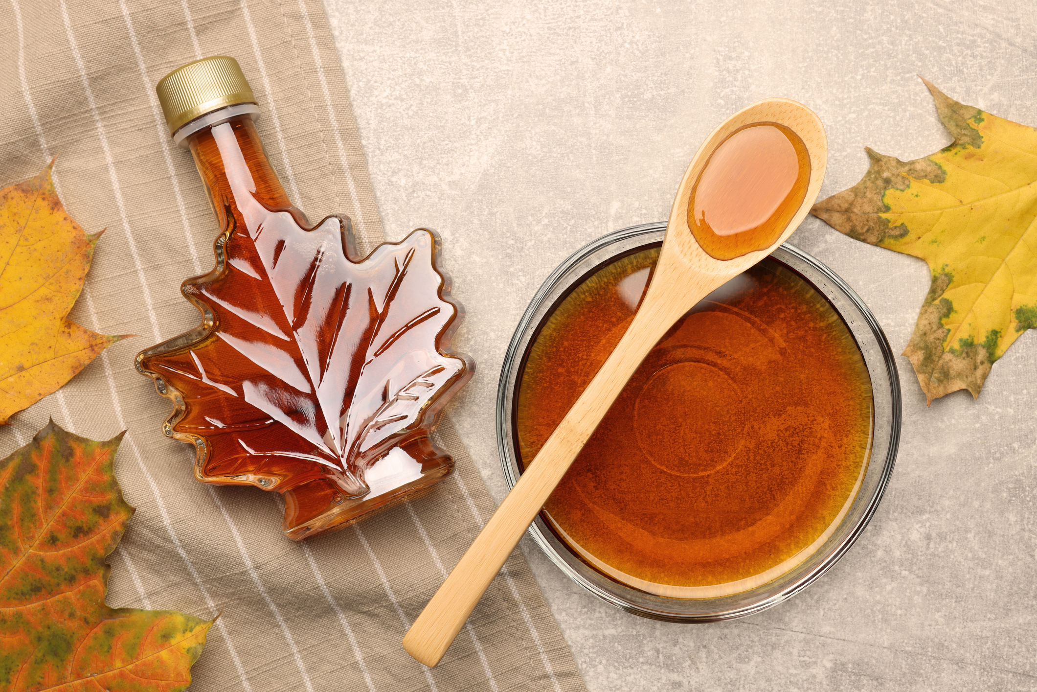 Flat lay composition with tasty maple syrup and dry leaves on light ...
